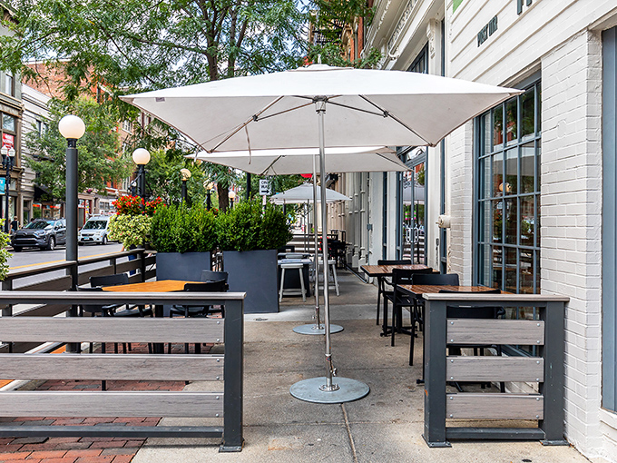 The Eagle's outdoor patio beckons like an urban oasis, where mint-green walls and white umbrellas create the perfect backdrop for Cincinnati people-watching.