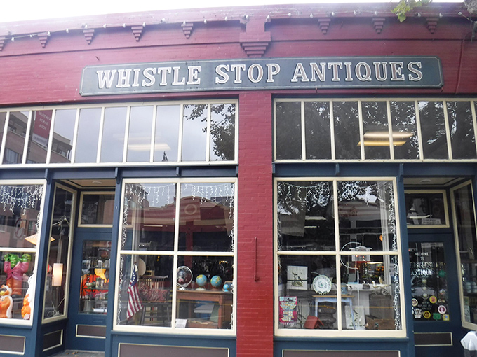 The brick-red facade of Whistlestop Antiques beckons like a time portal. Those windows offer just a tantalizing glimpse of the treasures waiting inside.