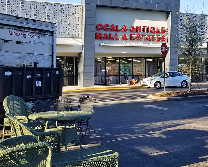 The bright red signage beckons like a siren song to treasure hunters. Outside, vintage patio furniture hints at the wonderland waiting within.