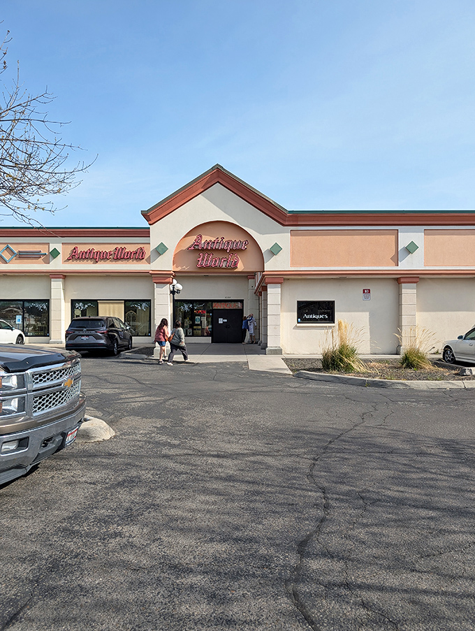 The peach-colored facade of Antique World Mall beckons treasure hunters with its distinctive arched entrance &ndash; like a portal to nostalgia waiting to be explored.