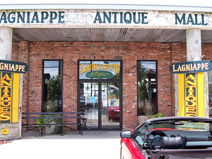 The brick facade of Lagniappe Antique Mall welcomes treasure hunters with the promise of discoveries waiting inside. Louisiana's version of Ali Baba's cave stands ready to reveal its secrets.