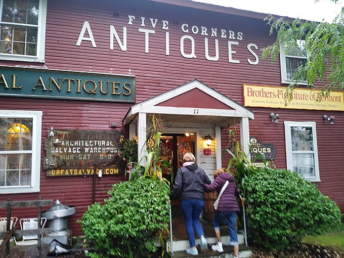 The iconic red exterior of Five Corners Antiques stands like a time portal in Essex Junction, beckoning treasure hunters with promises of discoveries waiting inside.