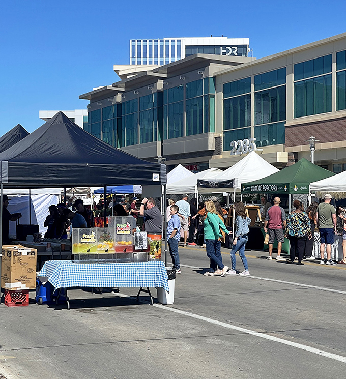 The urban backdrop of Aksarben Village creates a perfect contrast to the rustic charm of white tents and farm-fresh offerings.