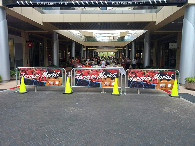 The entrance to flavor town! Bright banners and yellow cones mark the spot where culinary adventures begin at Downtown Summerlin Farmers Market.