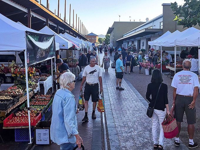 The bustling corridor of white tents at Santa Fe Farmers Market creates a gastronomic runway where shoppers hunt for treasures grown in New Mexico soil.