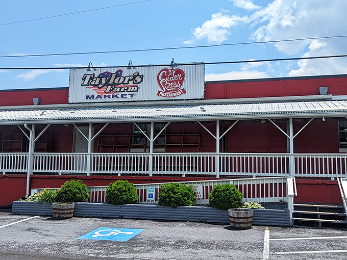 The classic red barn exterior of Taylor's Farm Market stands as a beacon of agricultural authenticity in Inwood, complete with welcoming white porch railings that practically whisper "come on in."