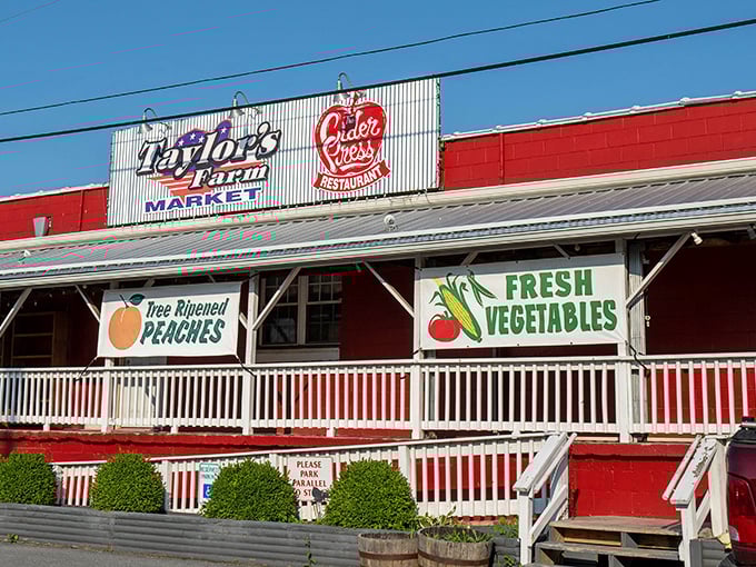 The classic red barn exterior of Taylor's Farm Market stands as a beacon of agricultural authenticity in Inwood, complete with welcoming white porch railings that practically whisper "come on in."