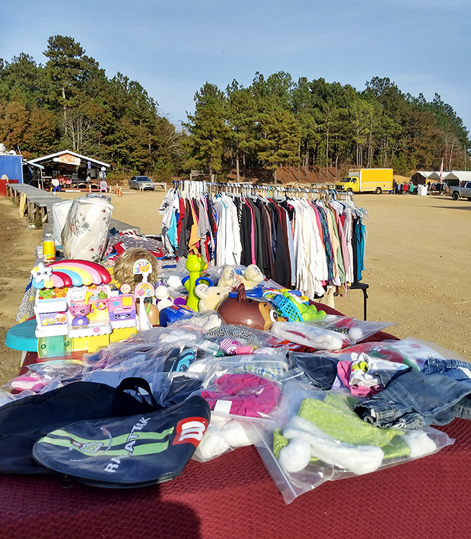 The ultimate fashion buffet spread across sandy grounds. Racks of clothing await new homes while shoppers hunt for that perfect addition to their wardrobe.