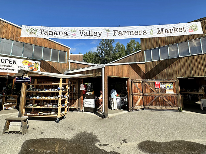 The rustic wooden entrance to Tanana Valley Farmers Market welcomes visitors like a cabin-sized invitation to Alaska's bounty.