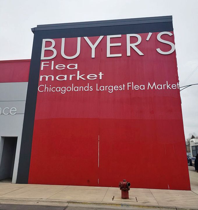 The bold red facade of Buyer's Flea Market stands like a beacon for bargain hunters, promising treasures within its walls. 