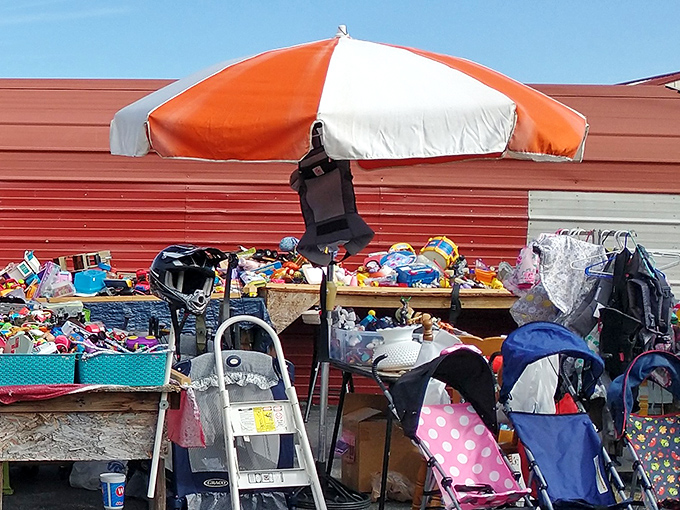 One person's garage overflow becomes another's treasure trove. Under that orange and white umbrella lies someone's next conversation piece.