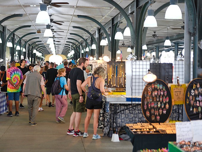 The French Market's iconic colonnade stretches like a treasure-filled runway, where ceiling fans lazily stir the air above a shopper's paradise.