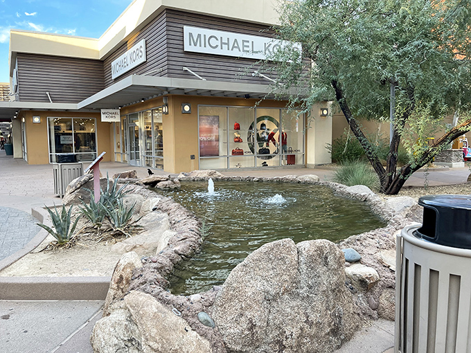 The grand entrance to Phoenix Premium Outlets stands like a desert mirage, promising retail treasures beneath that brilliant Arizona blue sky.