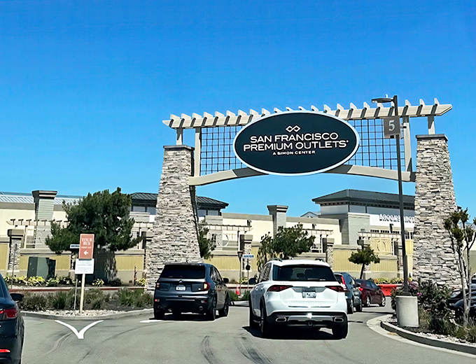 The grand entrance to bargain paradise beckons with its stone pillars and California sunshine &ndash; retail therapy awaits beyond those gates.