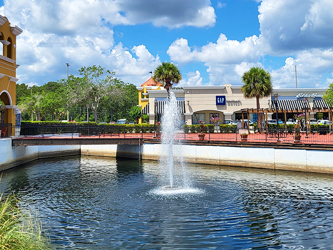 A serene fountain welcomes shoppers like a tropical oasis in the retail desert. The perfect spot to contemplate your next bargain conquest.