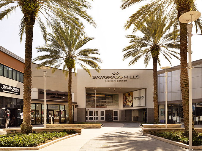 Palm trees stand sentinel at Sawgrass Mills' entrance, nature's way of saying "Your credit card is about to get a tropical workout."