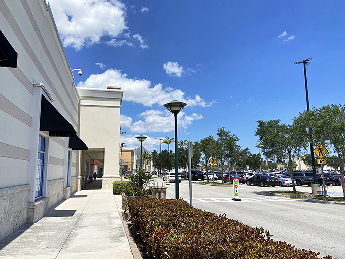 The Florida sky puts on its best blue backdrop for Palm Beach Outlets, where shopping dreams come true under swaying palms and puffy clouds.