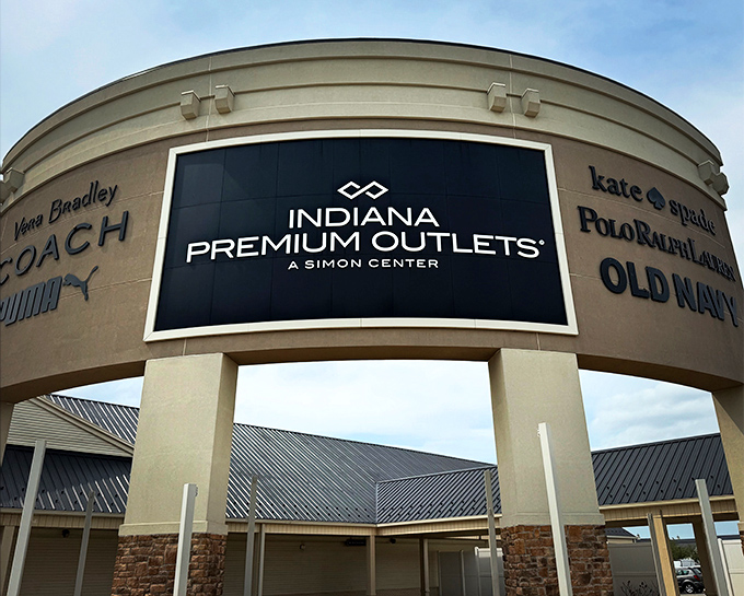 The grand entrance announces retail royalty with Coach, Kate Spade, and Polo Ralph Lauren—like a Hollywood marquee for your wallet's starring role in "Discount Dynasty."