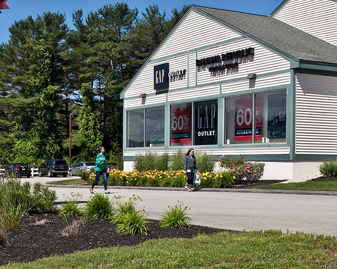 Classic New England architecture meets modern retail therapy at the Gap and other storefronts, where 60% off signs are the local language.