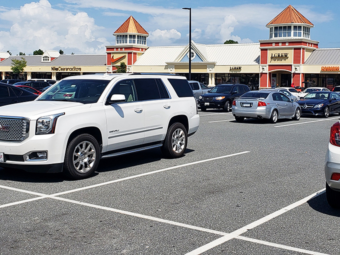 The iconic red-roofed entrance to Outlets Ocean City welcomes shoppers like a retail Emerald City at the end of a bargain-hunting yellow brick road.
