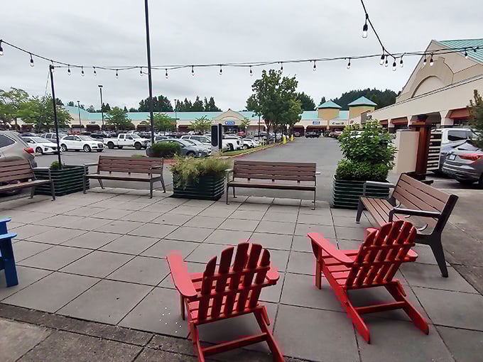 Those cheerful red Adirondack chairs aren't just for show&mdash;they're strategic resting spots for when your shopping bags become their own workout routine.