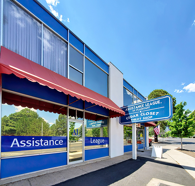 The blue and red exterior of Cedar Closet Thrift Shop stands like a beacon of bargain possibilities under Arizona's brilliant sky. Happy hunting awaits!