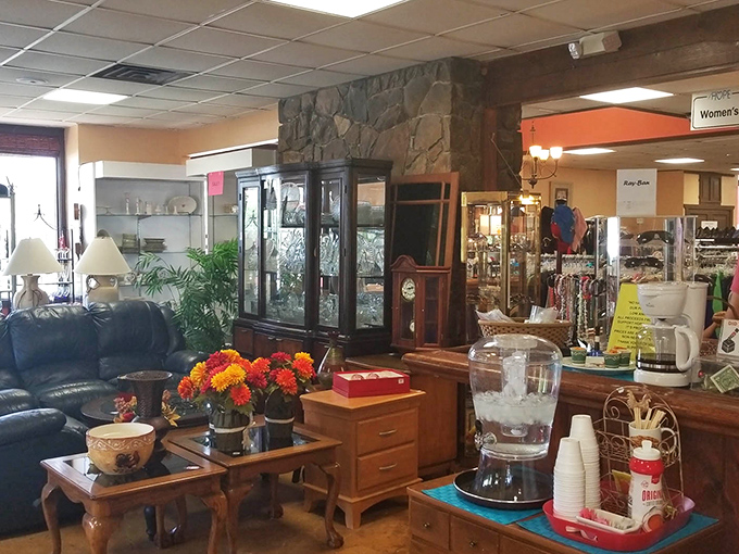 A living room vignette that could be straight out of a design magazine, complete with leather sofa, vintage china cabinet, and fresh flowers &ndash; all waiting for their second act.