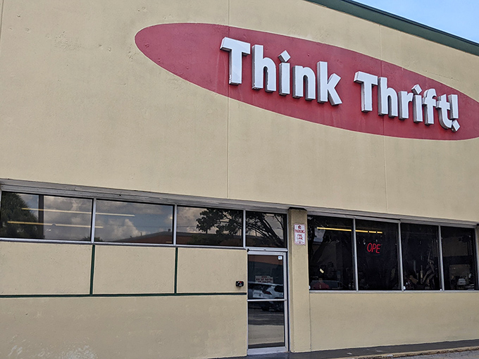 The iconic red oval logo of Think Thrift beckons bargain hunters like a retail lighthouse in a sea of overpriced shopping options.