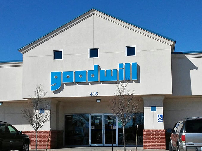 The bright blue Goodwill sign beckons like a lighthouse for bargain hunters. Clean lines and ample parking&mdash;your treasure hunt begins here!