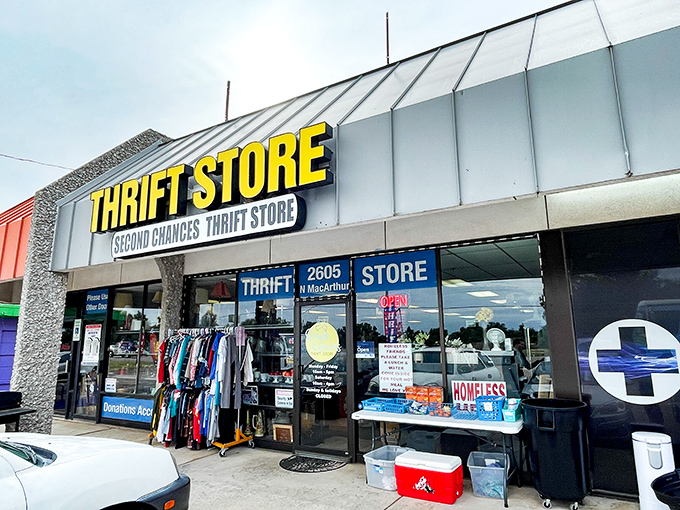 The bright yellow sign of Second Chances Thrift Store stands out like a beacon of bargain hope on MacArthur Boulevard, promising treasures within those unassuming walls.