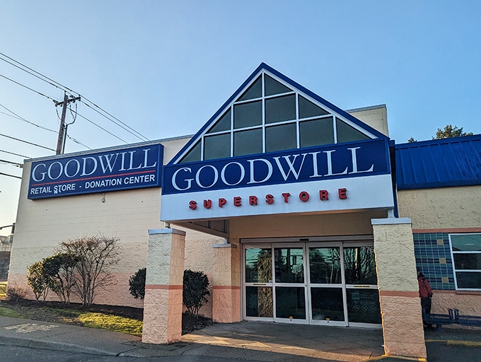 The blue-and-white facade of Goodwill's Aloha Superstore beckons like a beacon of bargain possibilities, promising treasures behind those automatic doors.