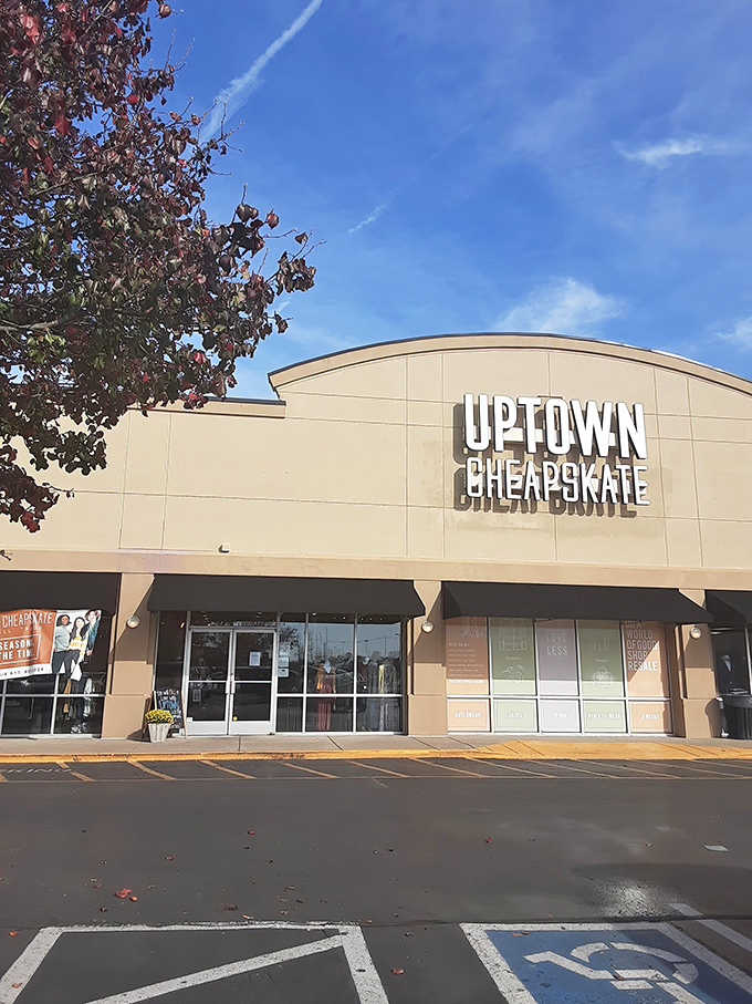 The beige facade of Uptown Cheapskate stands proudly against a brilliant Tennessee sky, promising fashion treasures within that won't break your budget.