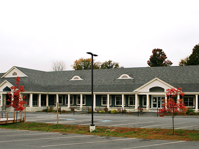 Fall foliage frames this thrifter's paradise, where maple trees drop their leaves and shoppers drop their jaws at the deals inside.