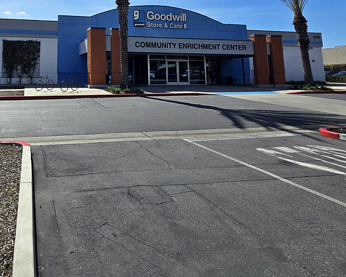 The blue facade of Goodwill's Community Enrichment Center stands ready to welcome treasure hunters into a world where one person's castoffs become another's discoveries.
