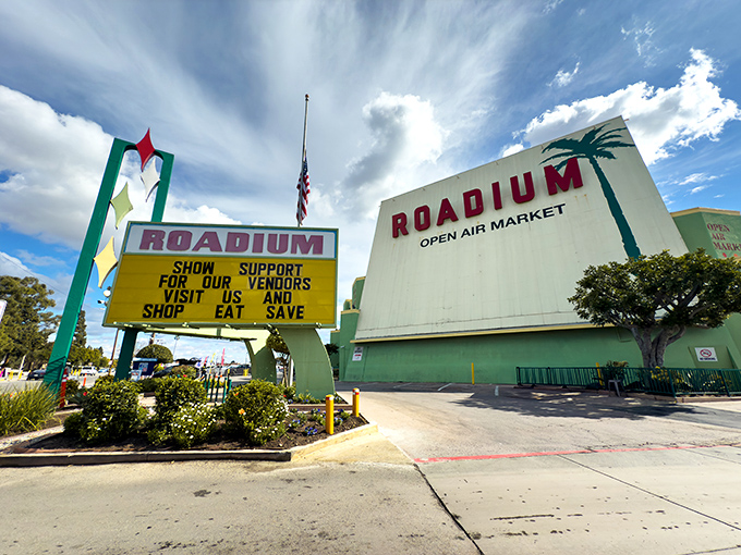 The iconic mint-green entrance to The Roadium stands like a retro portal to bargain paradise, beckoning treasure hunters under the California sun.