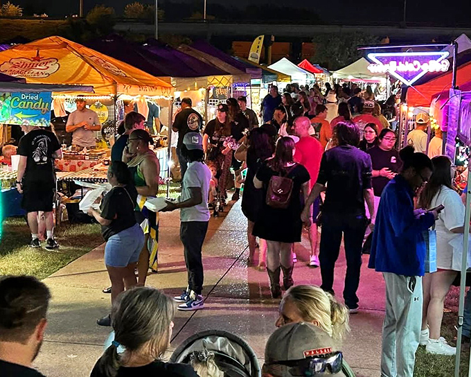 The night comes alive under a canopy of colorful tents, where strangers become friends and every aisle promises a new discovery.