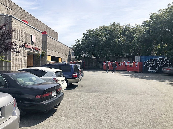 A quiet corner of Geary Boulevard where the red shield marks a familiar stop for thrifters hunting for hidden gems among the donations.