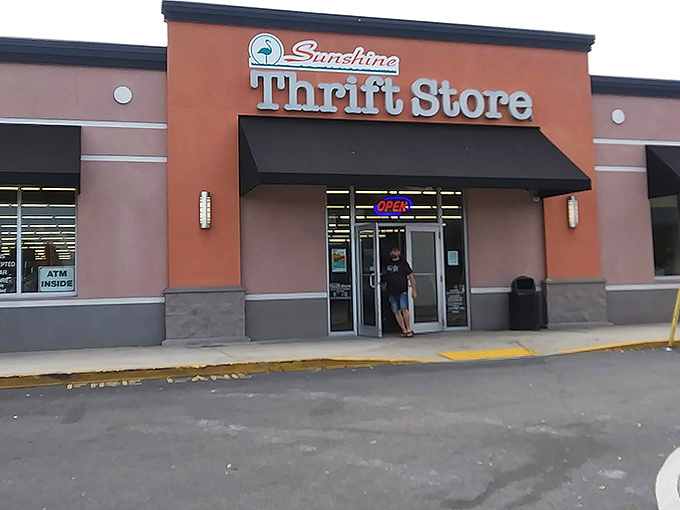 The distinctive orange facade of Sunshine Thrift Store beckons bargain hunters like a retail lighthouse guiding ships to treasure-filled shores.