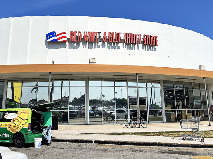 The curved white facade of Red White & Blue Thrift Store stands like the Taj Mahal of bargain hunting in Hialeah, beckoning treasure seekers with patriotic promise.
