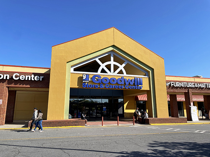 The yellow facade of Goodwill beckons like a treasure chest waiting to be opened, promising adventures in secondhand splendor on Atlanta's Buford Highway.