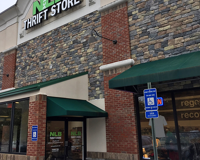 The stone and brick exterior of NLB Thrift Store promises treasure hunting adventures within, like a castle guarding vintage gold.