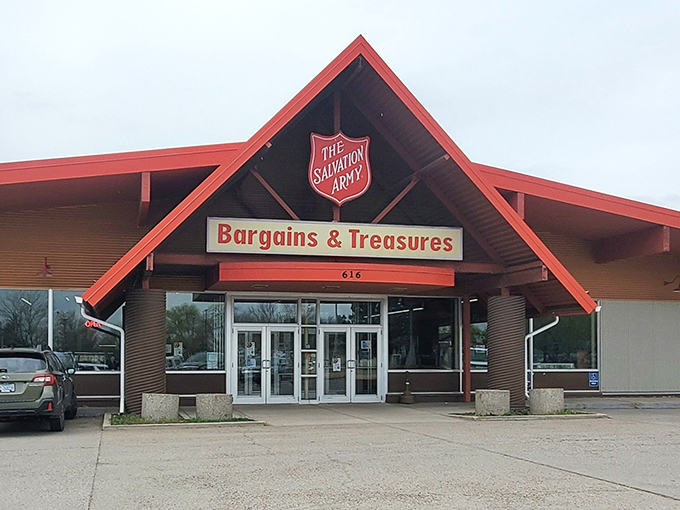 The iconic red-roofed Salvation Army Family Store stands like a beacon of bargain possibilities against Montana's big sky, promising treasure hunts that Costco shoppers can only dream about.