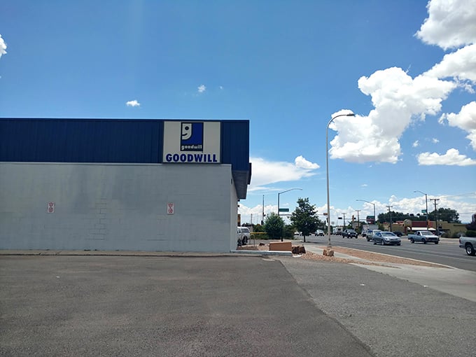 The iconic blue-trimmed Goodwill stands like a treasure chest against Santa Fe's endless sky, promising adventures in bargain hunting.
