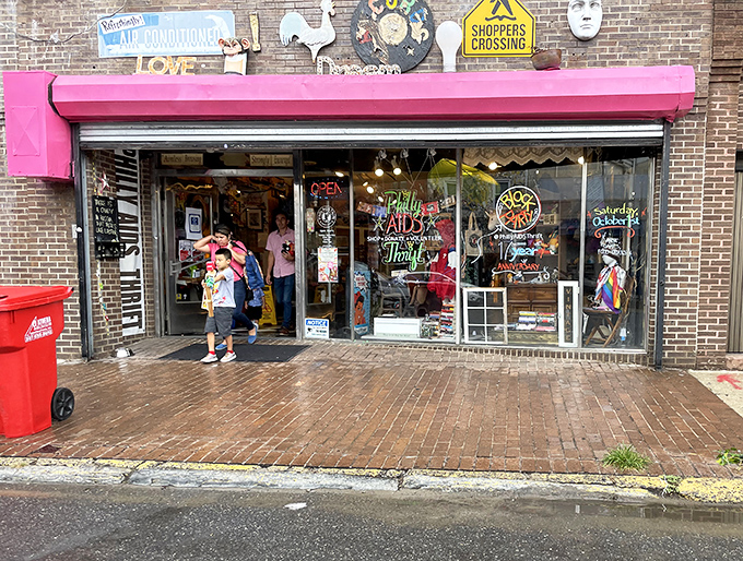 The iconic pink awning of Philly AIDS Thrift beckons bargain hunters like a beacon of secondhand salvation in Queen Village.