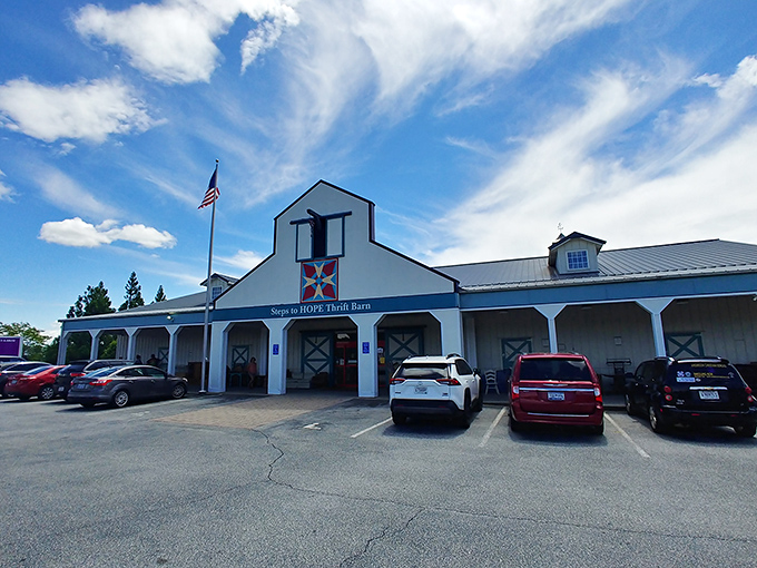 Blue skies frame this thrifter's paradise, where the American flag waves a patriotic hello and the spacious parking lot hints at the treasures waiting inside.