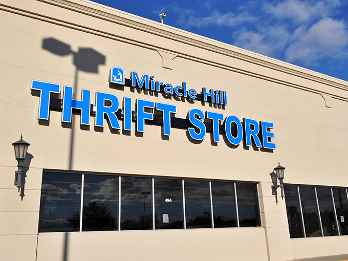 The iconic blue lettering of Miracle Hill Thrift Store beckons treasure hunters like a retail lighthouse on Pleasantburg Drive, promising adventures in secondhand paradise.