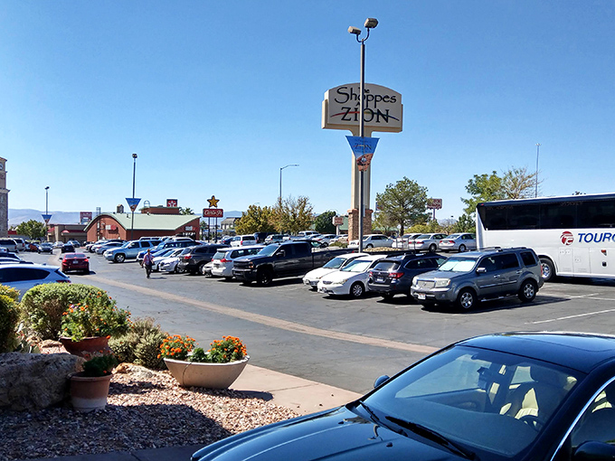 The iconic Shoppes at Zion sign stands tall against Utah's brilliant blue sky, beckoning bargain hunters like a retail lighthouse in a sea of savings.