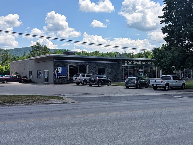 The Rutland Goodwill welcomes treasure hunters with its distinctive stone facade and blue signage, nestled against Vermont's rolling hills.