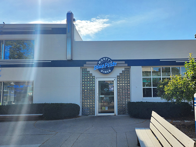 The gleaming white and blue exterior of Monty's Blue Plate Diner stands as a retro beacon on Atwood Avenue, promising nostalgic comfort with a progressive twist.