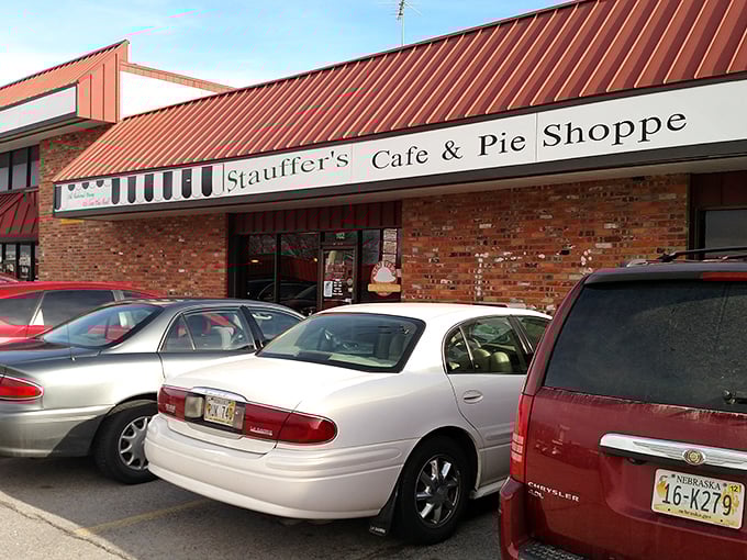 The iconic red-roofed exterior of Stauffer's beckons hungry travelers like a lighthouse for comfort food enthusiasts.